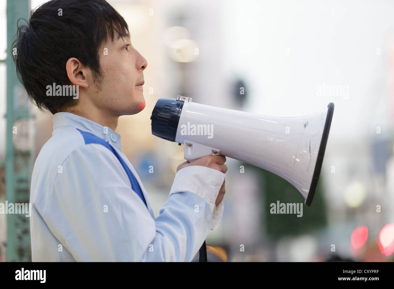 Japanese man talking in megaphone in Tokyo street, Japan Stock Photo ...