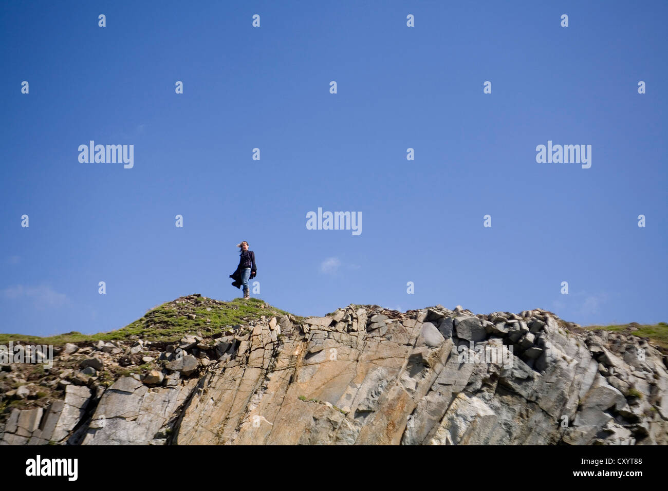 Young woman walking on cliff top in Wales Stock Photo - Alamy