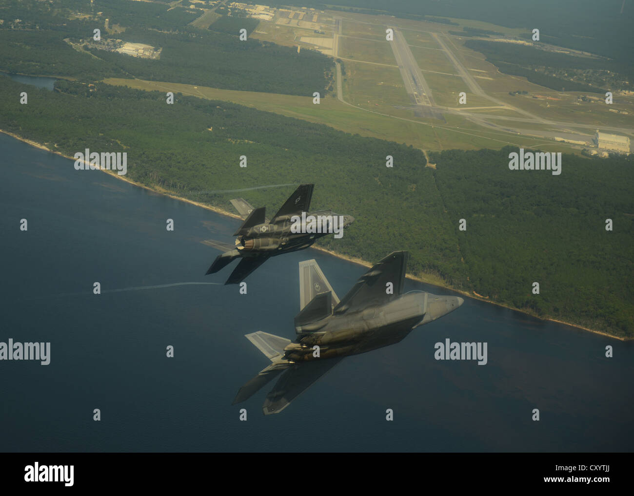 An F-35A Lightning II joint strike fighter and an F-22A Raptor Stock ...