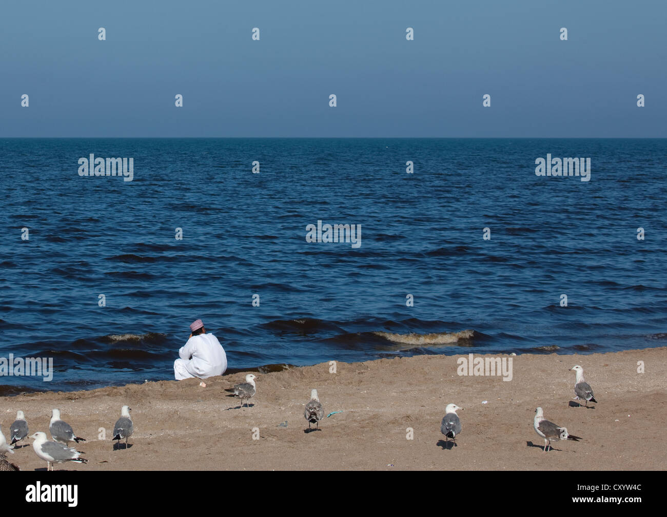 Back Of An Arabic Man Looking At Red Tide In Oman Sea Sitting Beside ...