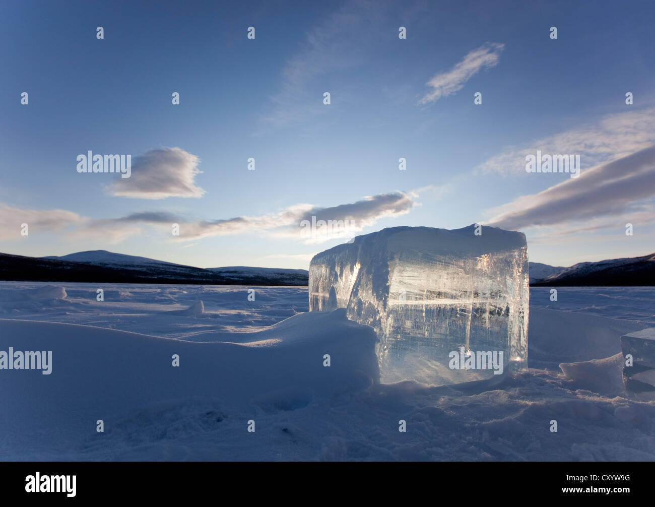 Clear ice cube on frozen Fish Lake, cut out with a chain saw, Yukon ...
