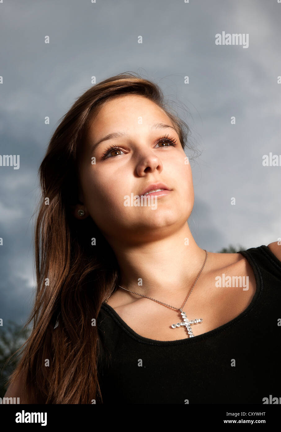 Girl, 14 years, in front of a cloudy sky, portrait Stock Photo - Alamy
