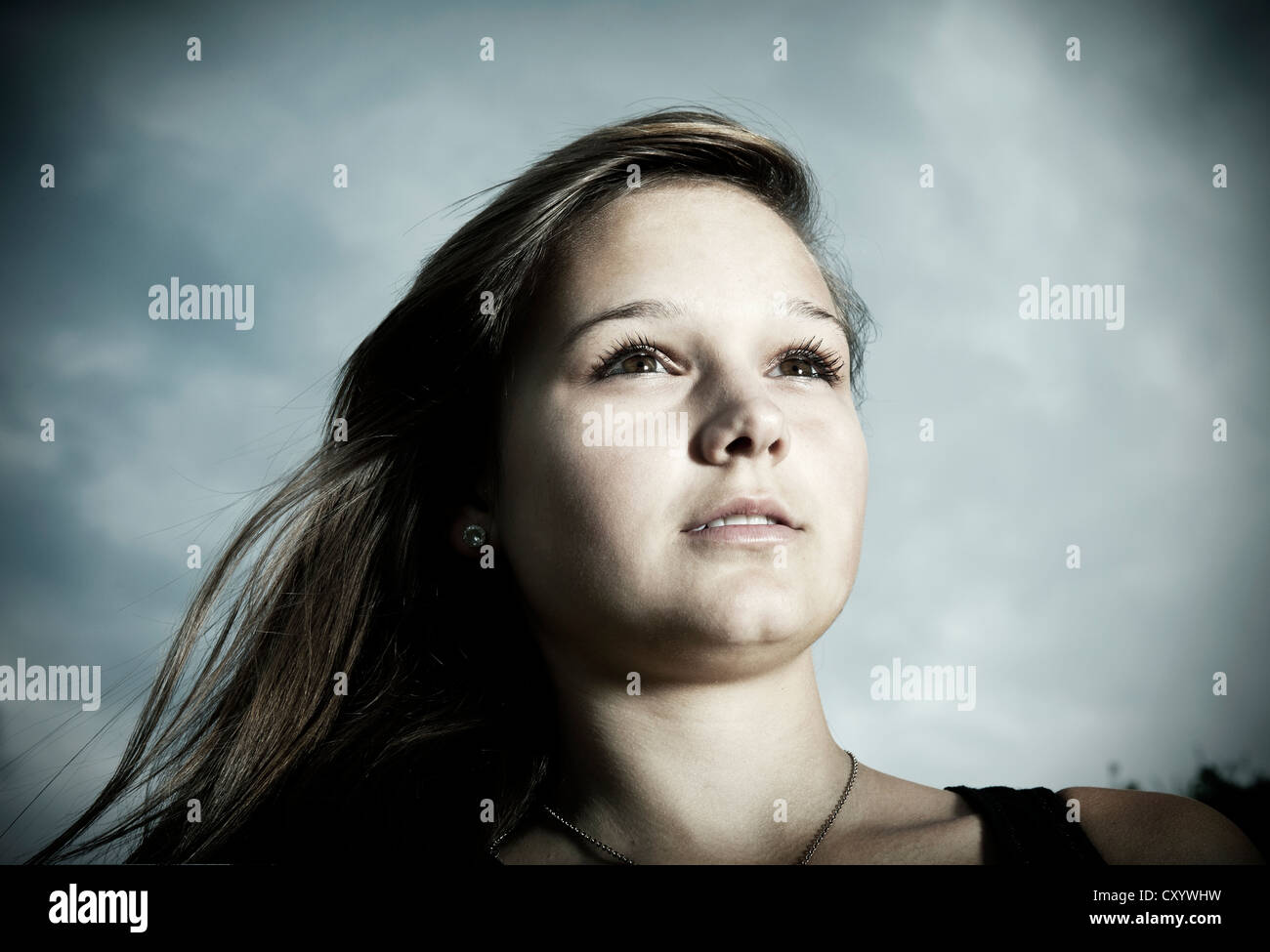 Girl, 14 years in front of a cloudy sky, portrait Stock Photo - Alamy