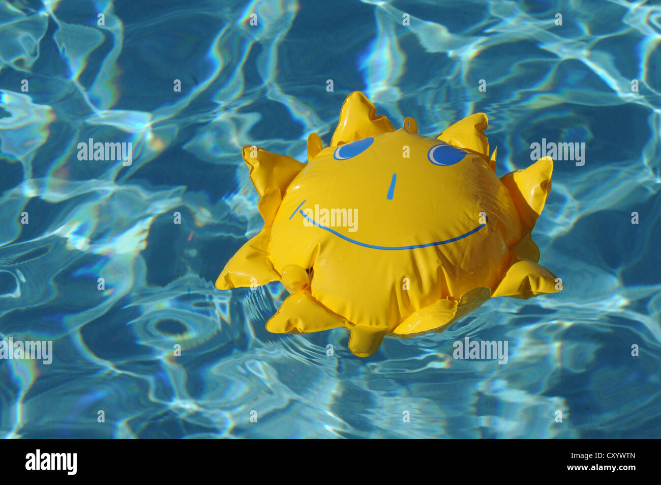 Toy sun floating in a swimming pool Stock Photo - Alamy
