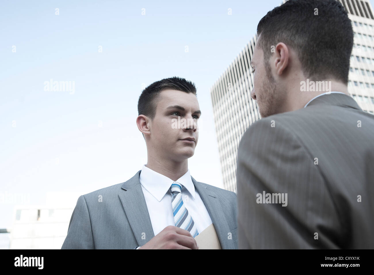 Businessman handing over an envelope Stock Photo - Alamy