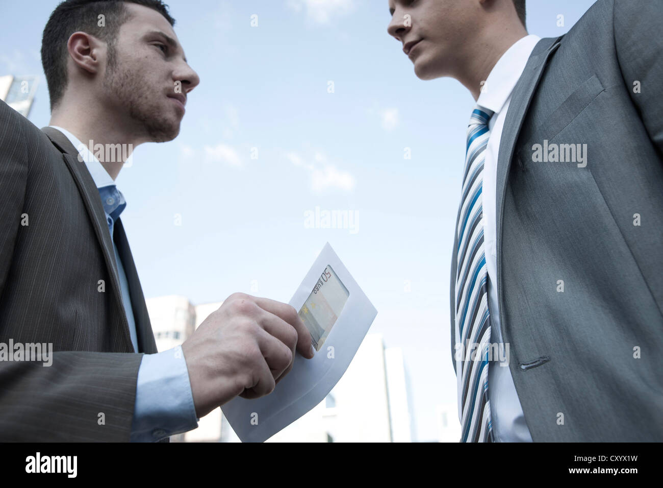 Businessman handing envelope over white hi-res stock photography and ...