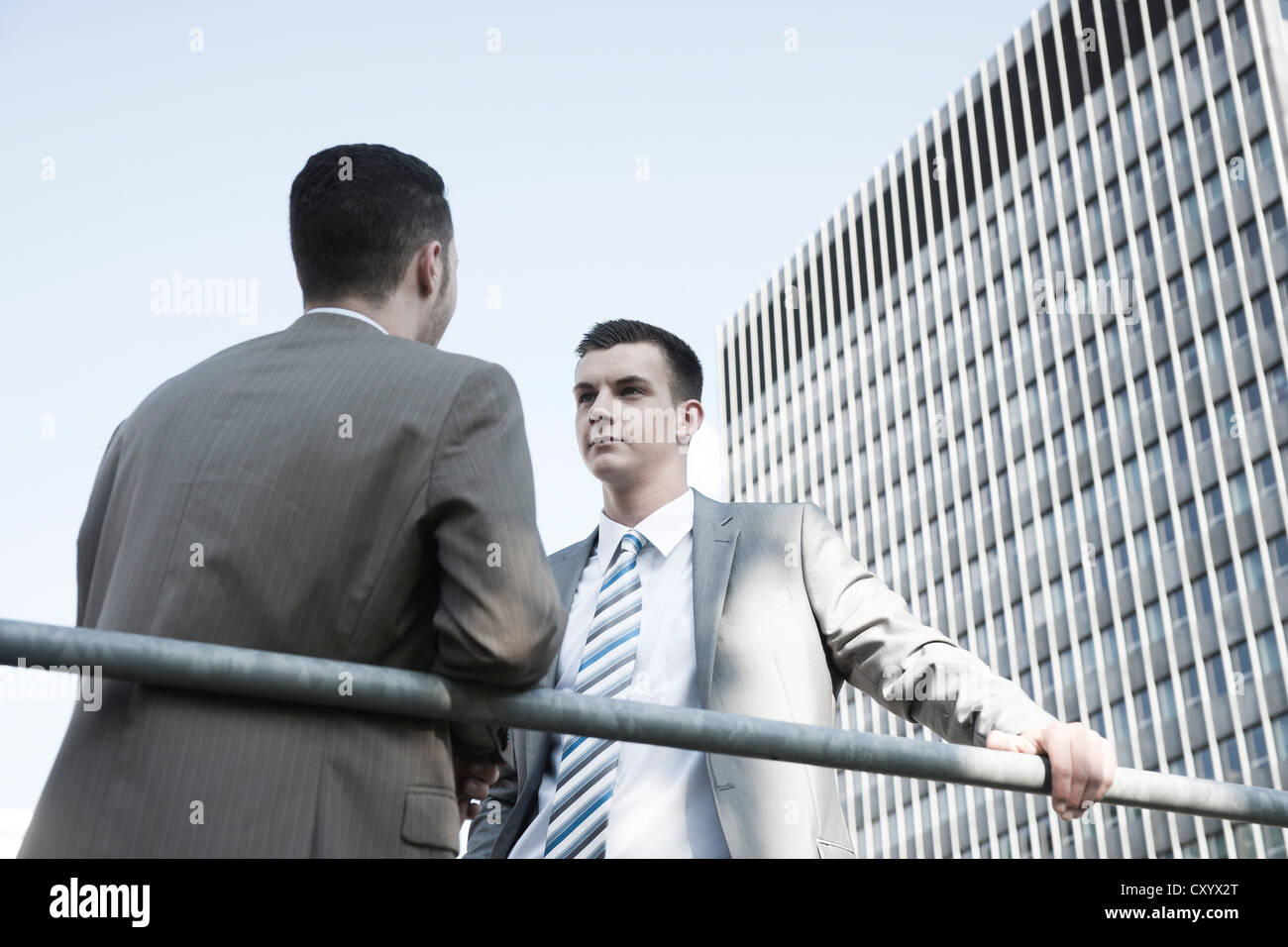 Two young businessmen in conversation Stock Photo - Alamy