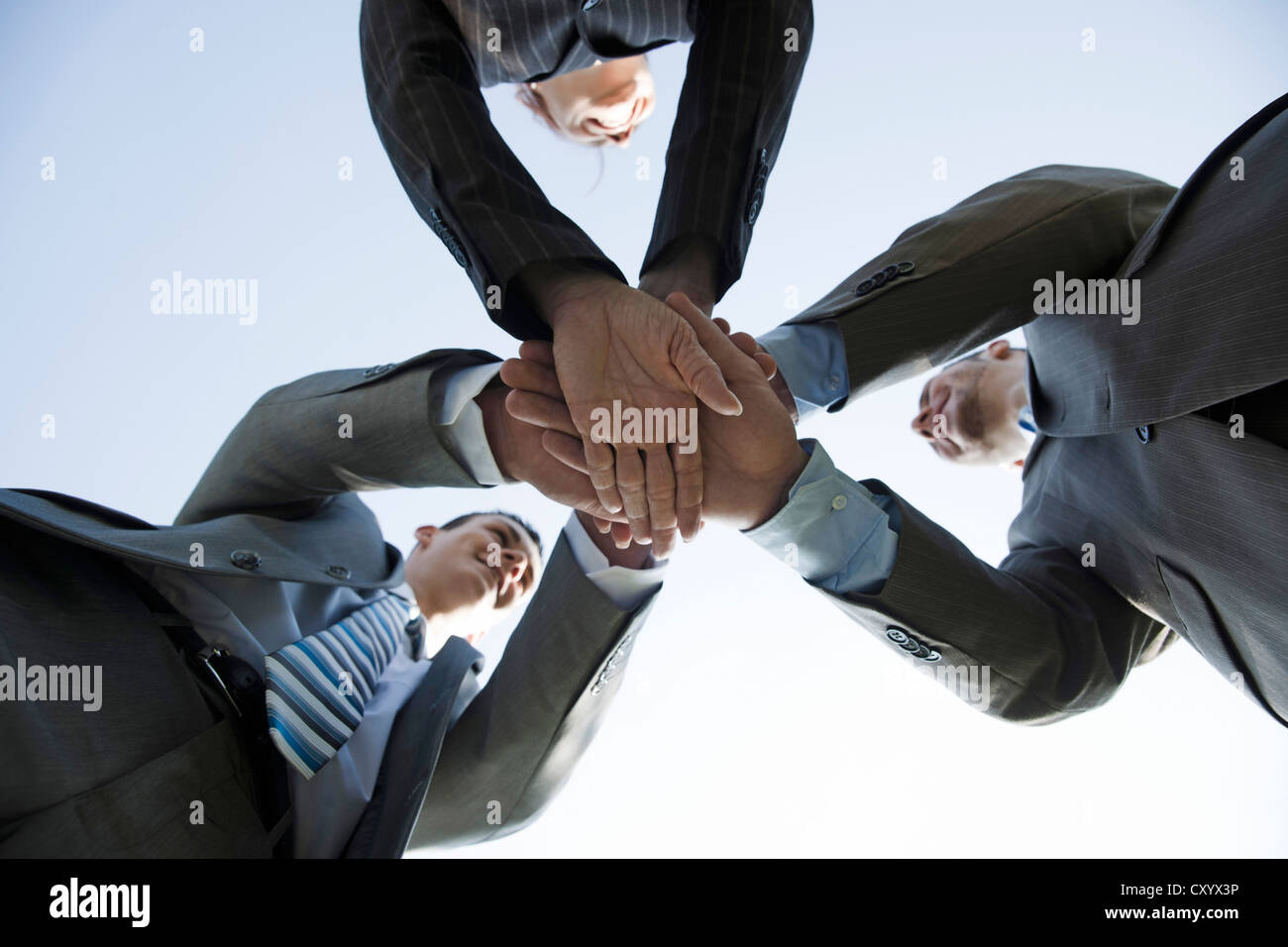 Business team joining hands to celebrate their success Stock Photo - Alamy