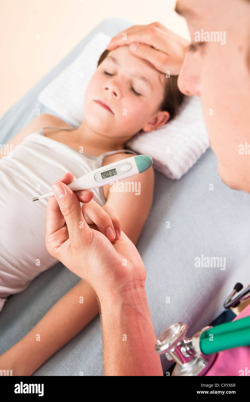 Fever, a pediatrician reading a digital fever thermometer showing ...