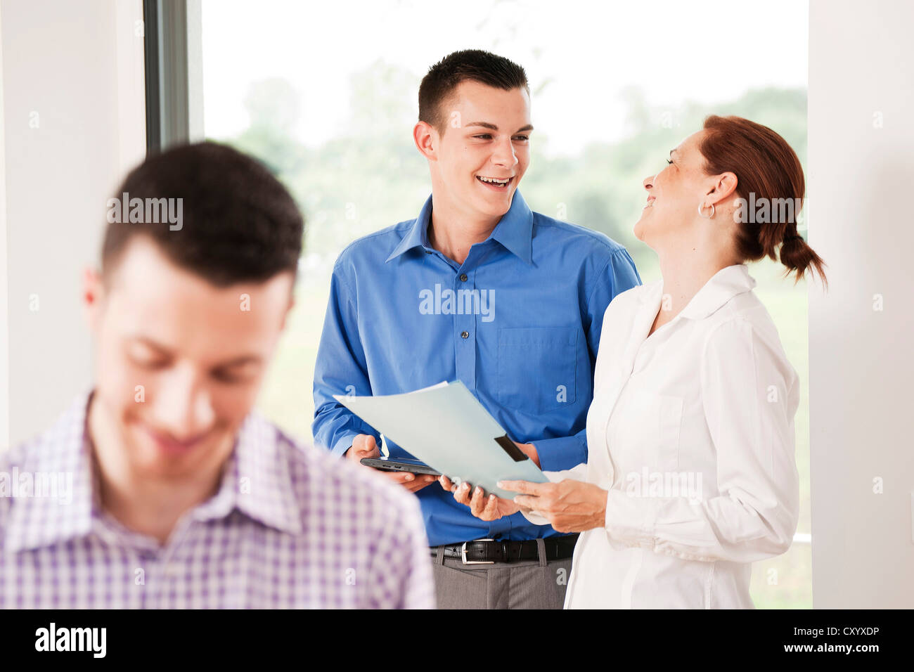 Good-humoured office team at work Stock Photo - Alamy