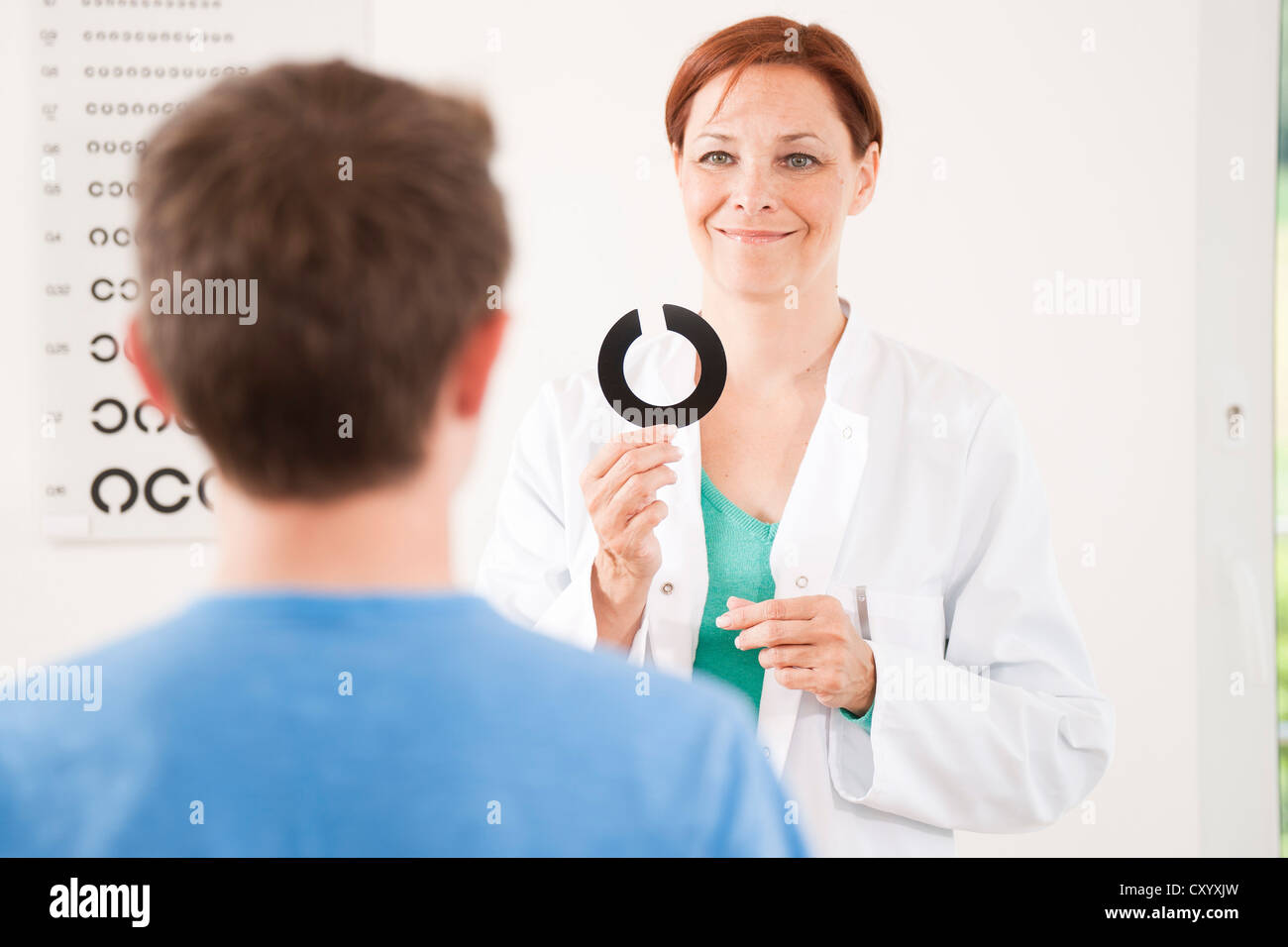 Teenager boy during a vision test at the ophthalmologist Stock Photo ...