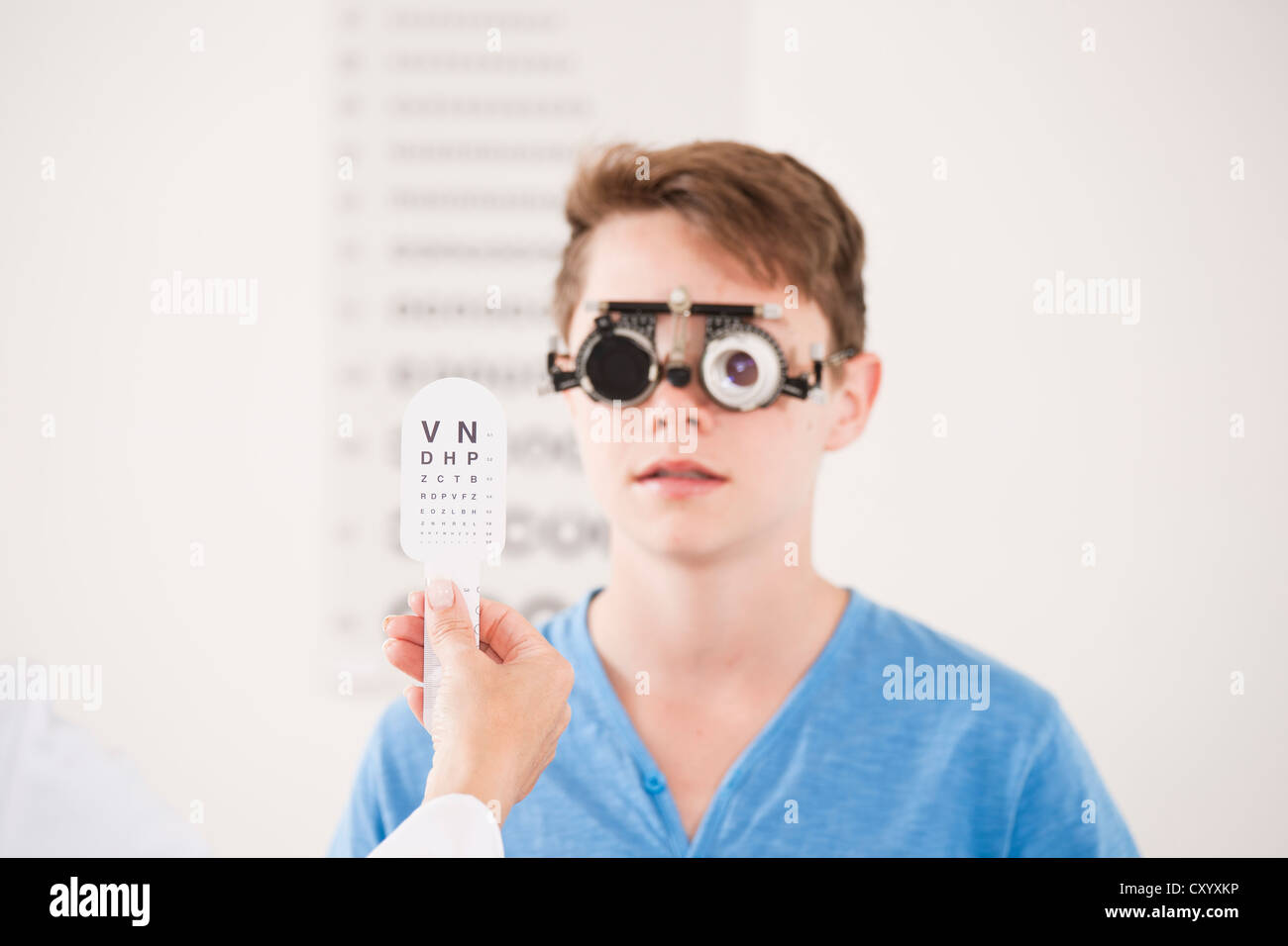 Teenager boy during a vision test at the ophthalmologist Stock Photo ...