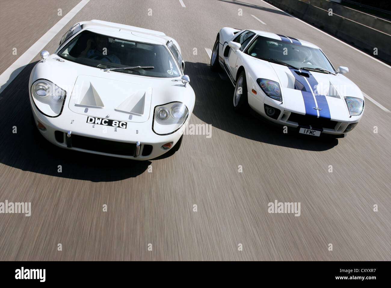 Old and new Ford GT40s driving down road Stock Photo - Alamy