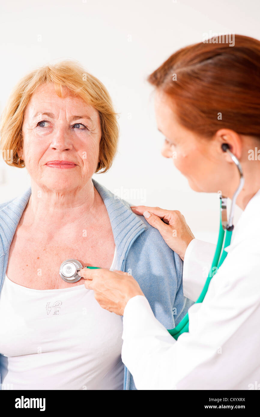 Patient being monitored by her family doctor with a stethoscope Stock ...