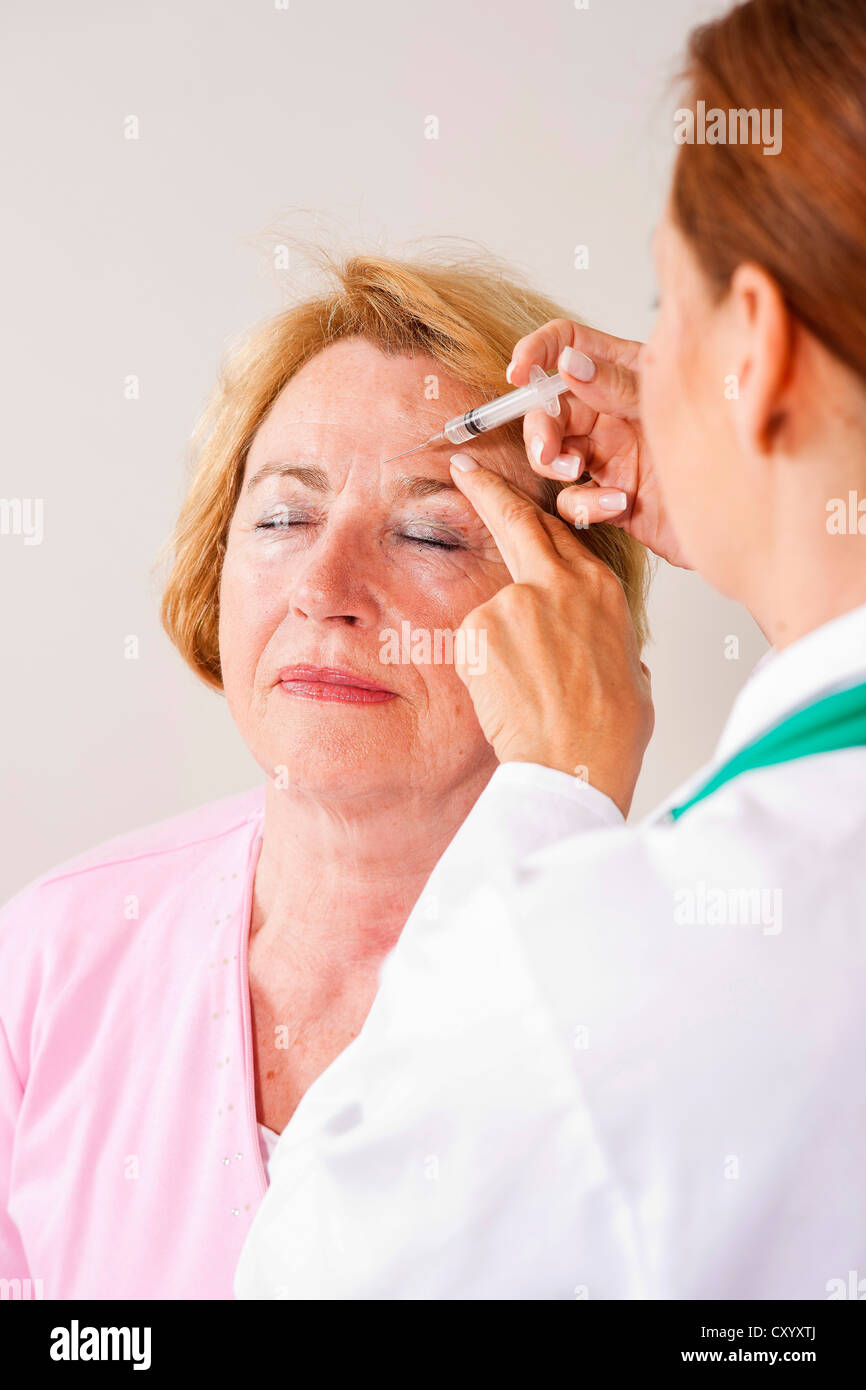 Patient receiving an injection in her face from a doctor Stock Photo ...