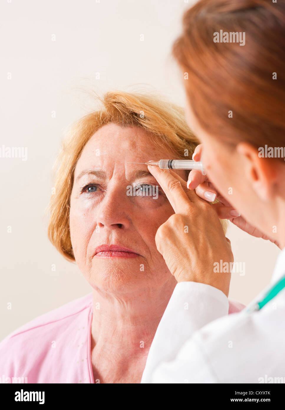 Patient receiving an injection in her face from a doctor Stock Photo ...