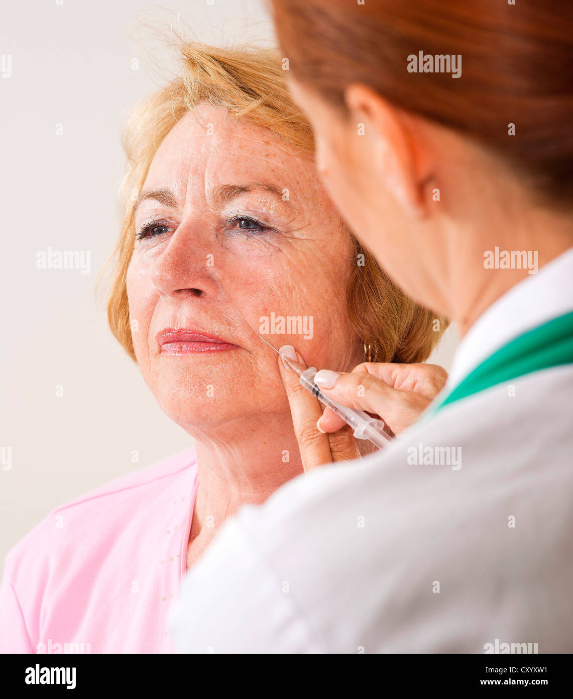 Patient receiving an injection in her face from a doctor Stock Photo ...