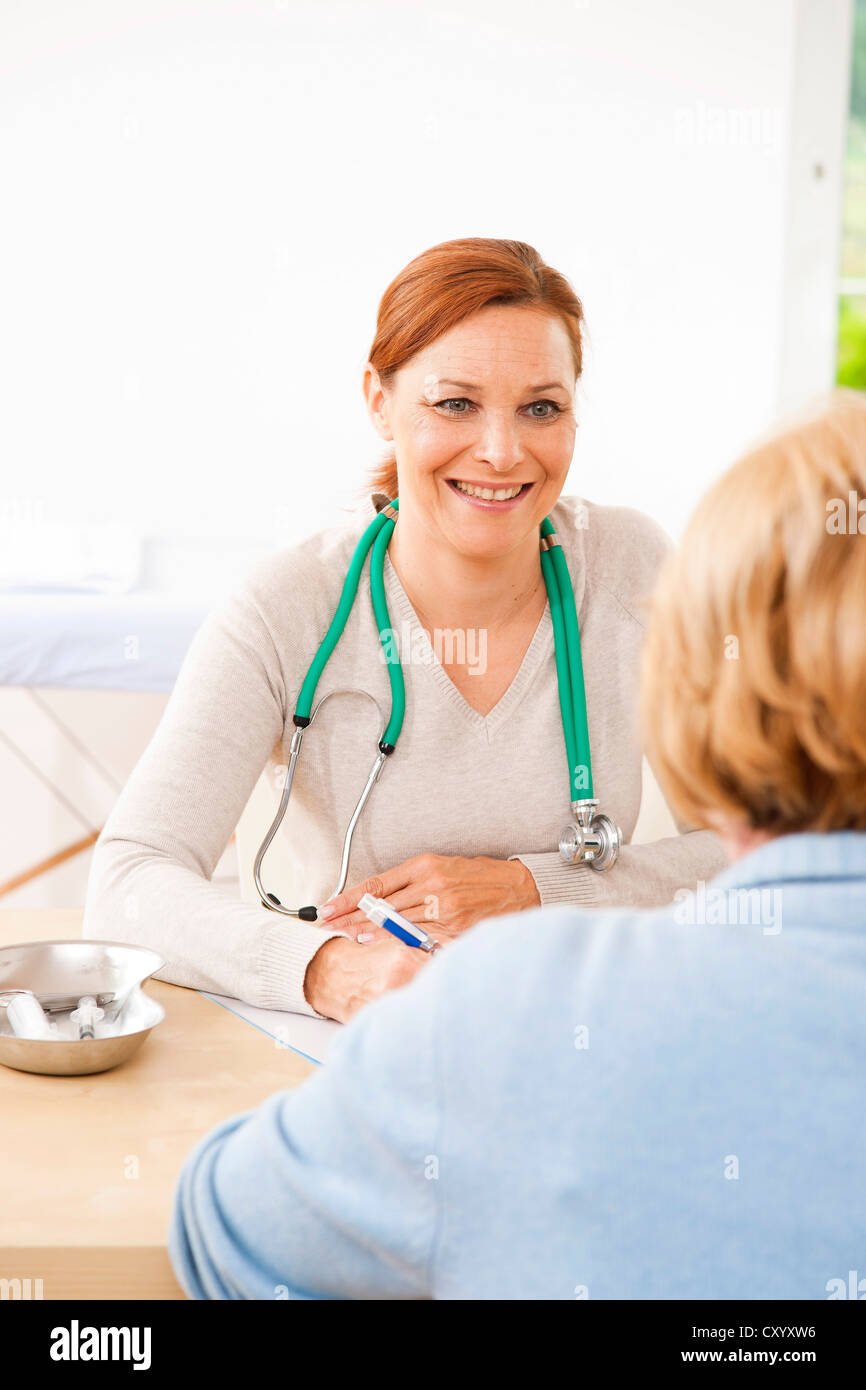 Woman in consultation with her doctor in a practice Stock Photo - Alamy