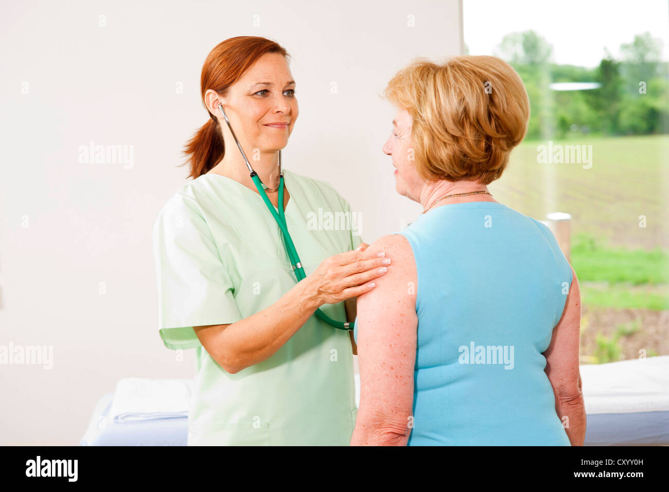 Gp attending to a patient hi-res stock photography and images - Alamy