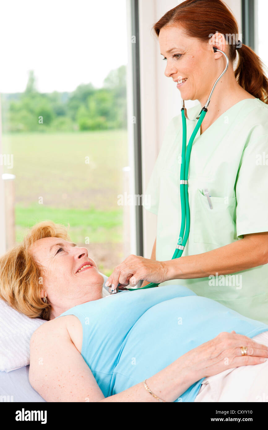 Patient being monitored by her family doctor with a stethoscope Stock ...