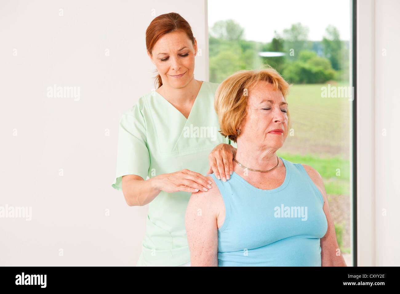 Patient being treated on her shoulder by a physiotherapist Stock Photo ...
