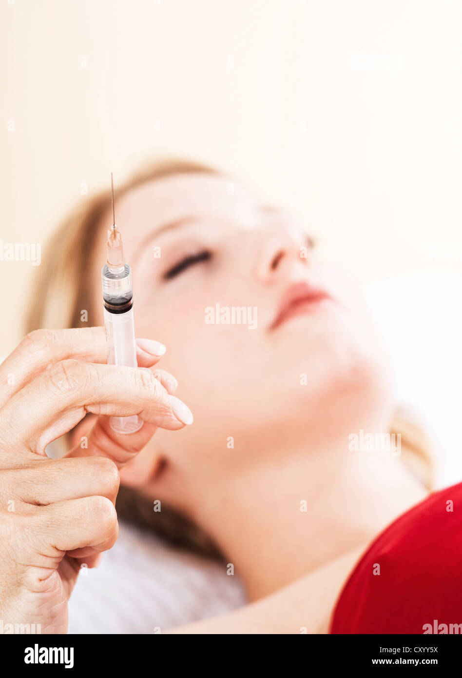 Syringe in front of the face of a patient, Botox treatment Stock Photo ...