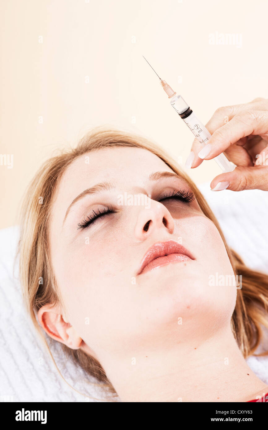 Syringe in front of the face of a patient, Botox treatment Stock Photo ...