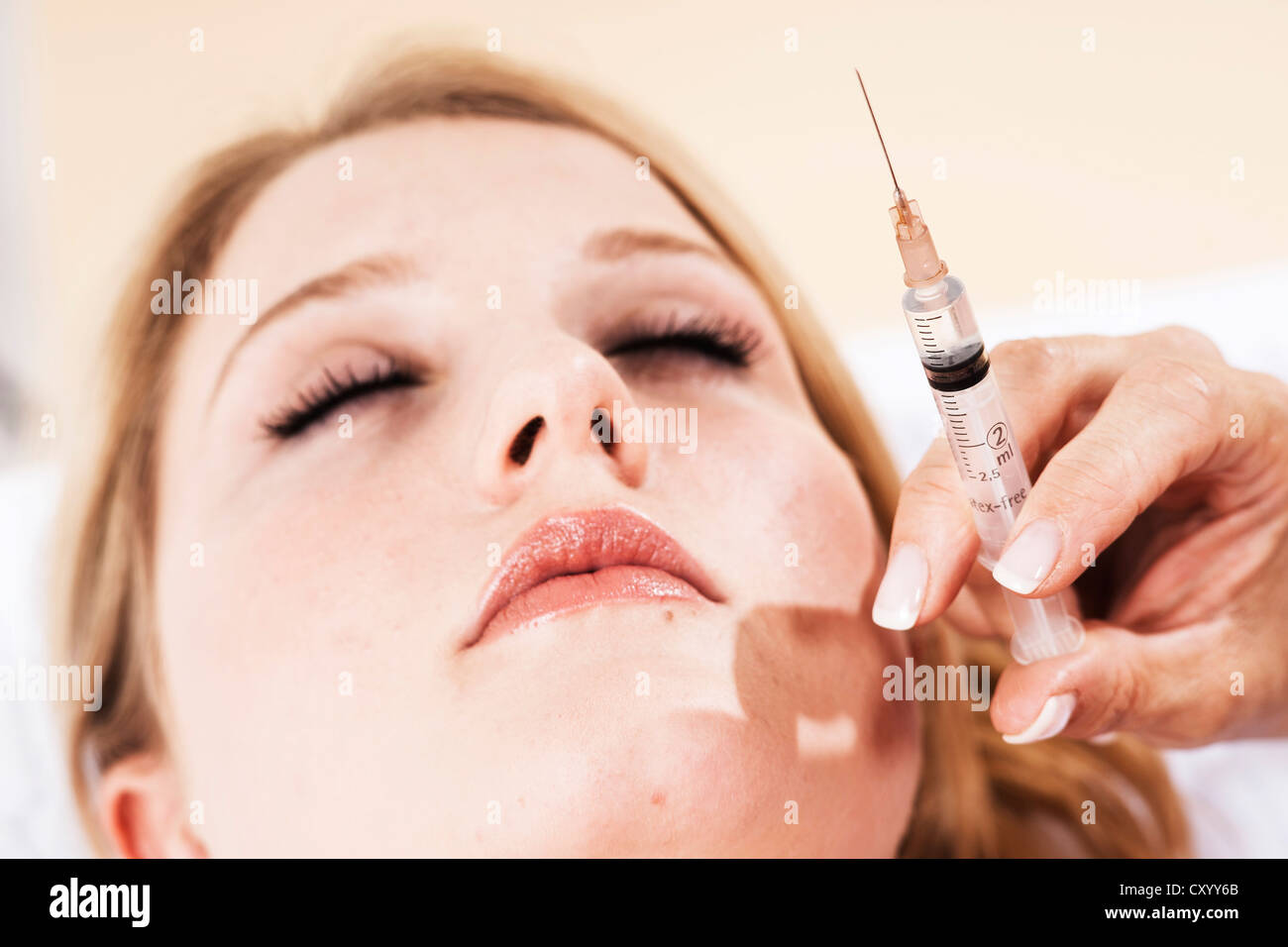 Syringe in front of the face of a patient, Botox treatment Stock Photo ...