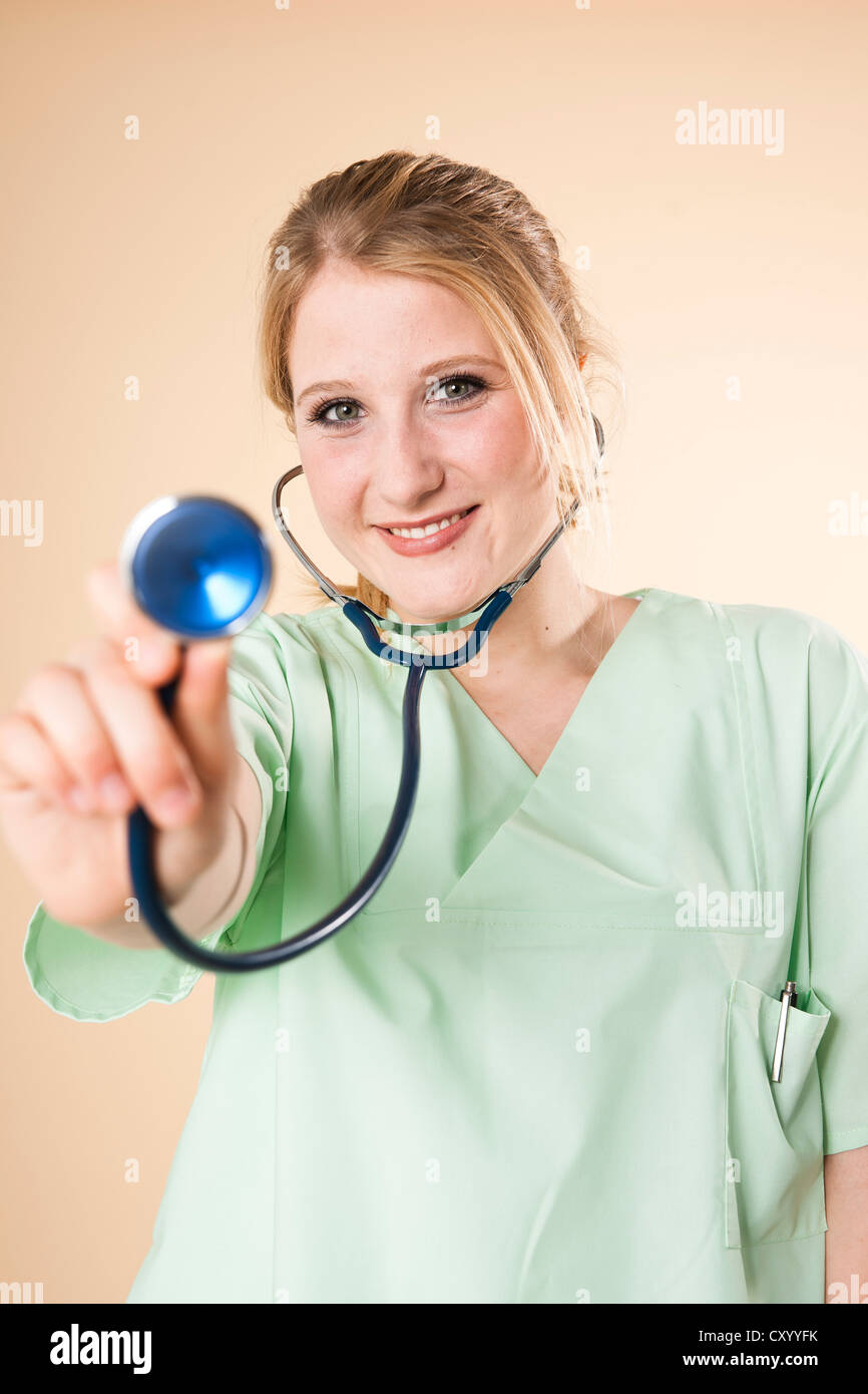 Nurse holding a stethoscope towards the front Stock Photo - Alamy