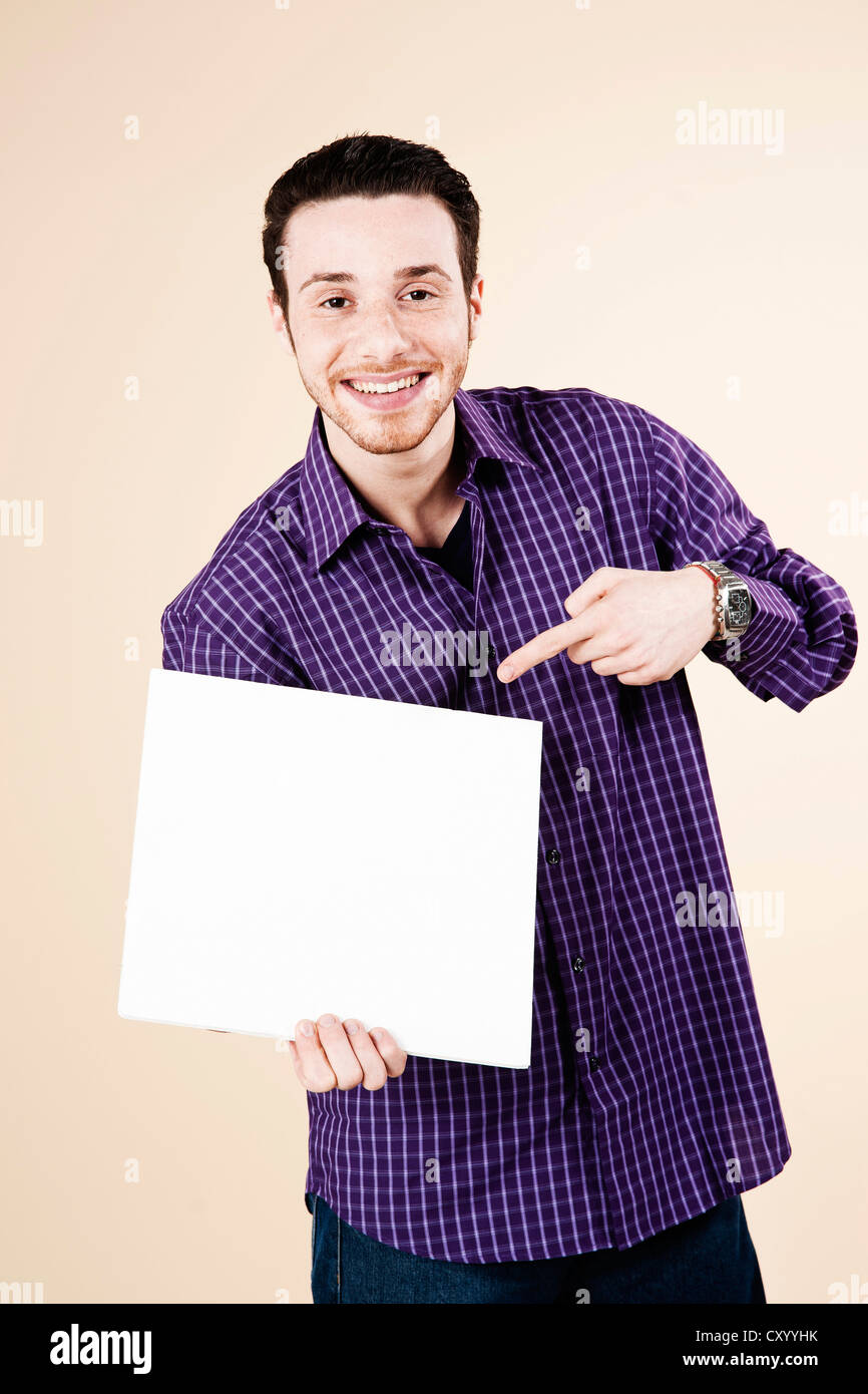 Young man pointing to a blank board in his hand Stock Photo - Alamy