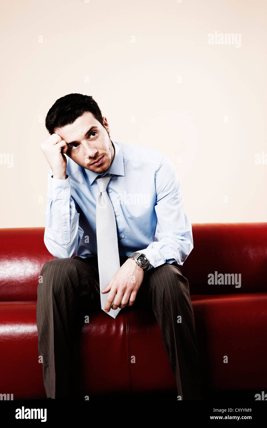 Thoughtful young man pensively sits hi-res stock photography and images ...