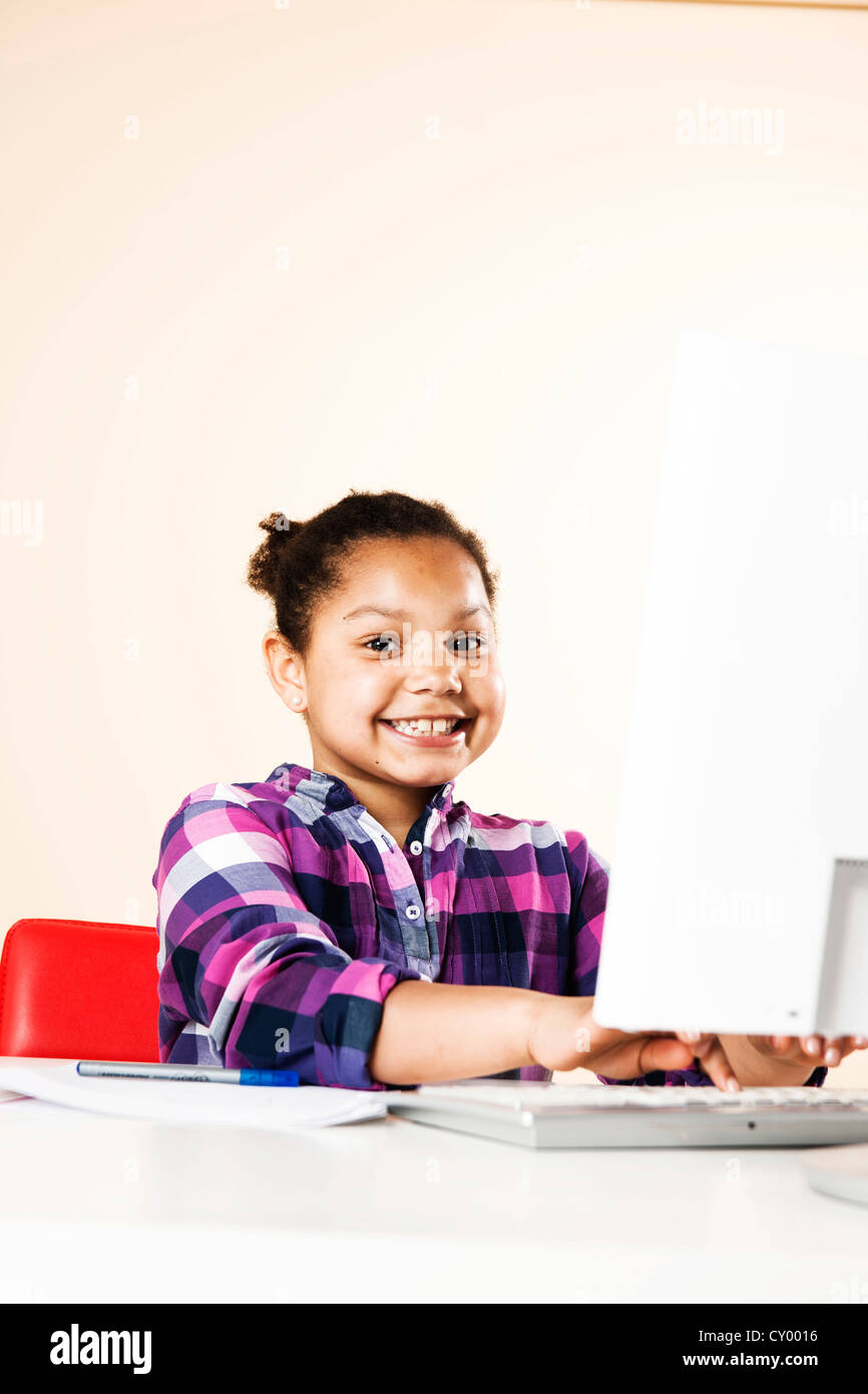 Cheerful girl working on her computer Stock Photo - Alamy