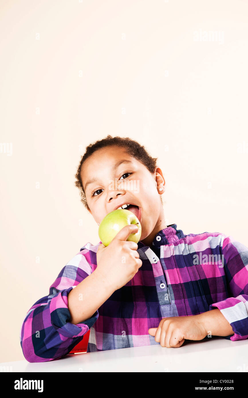 Girl biting an apple Stock Photo - Alamy