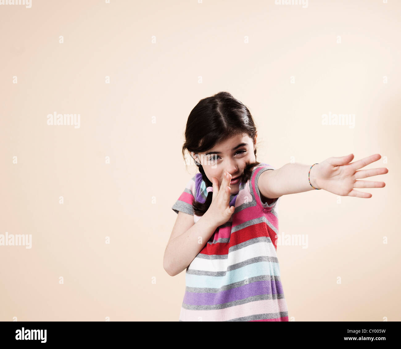 Girl pointing a little to one side Stock Photo - Alamy