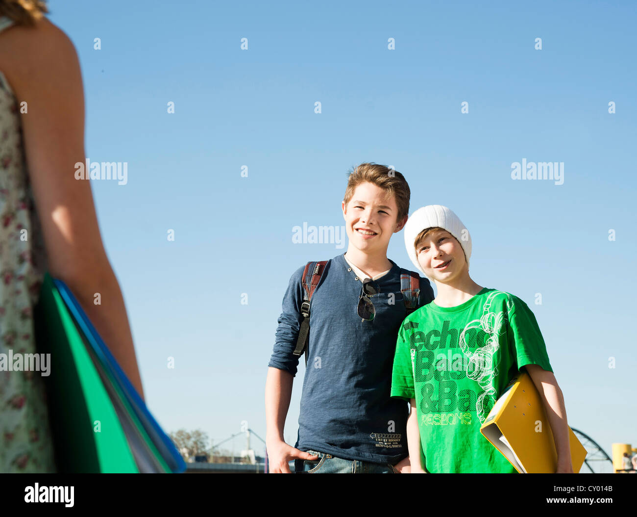 Two boys meeting a girl Stock Photo - Alamy