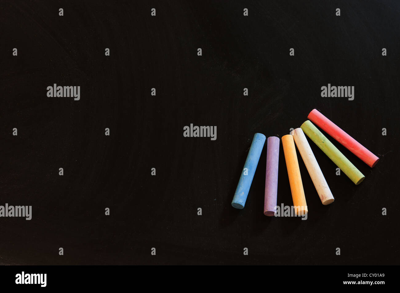 Blank chalkboard and group of colorful chalks Stock Photo - Alamy