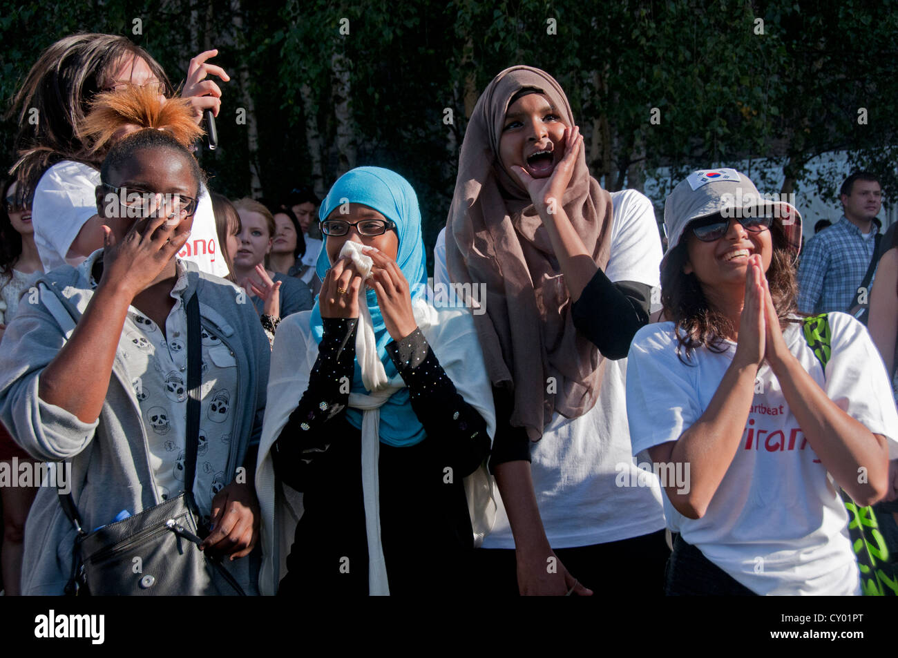 Group of young Muslim women listeni9ng to concert Stock Photo - Alamy