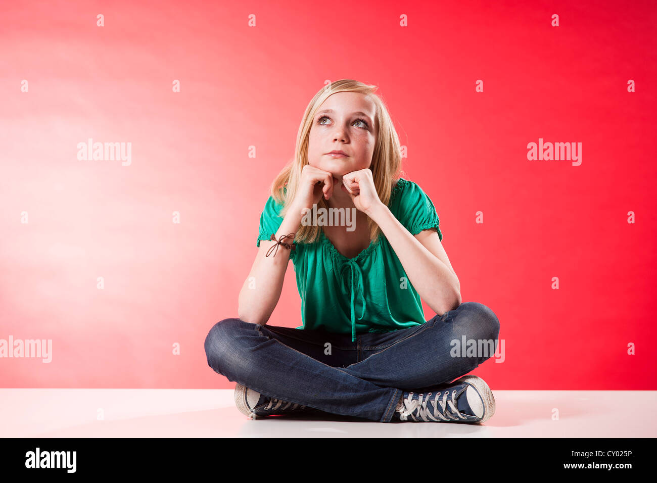 Sad girl sitting cross legged hi-res stock photography and images - Alamy