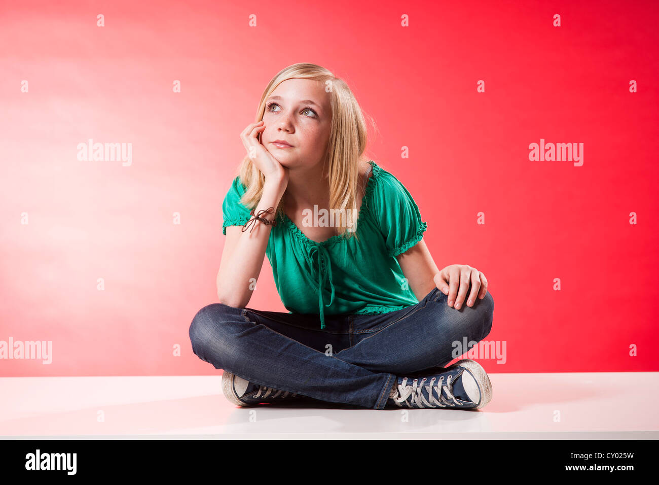 Sad girl sitting cross legged hi-res stock photography and images - Alamy
