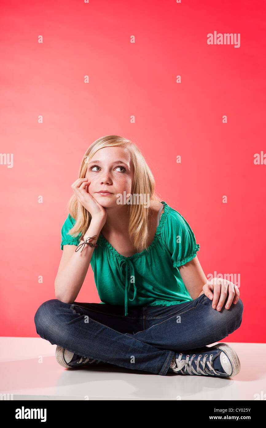 Sad girl sitting cross legged hi-res stock photography and images - Alamy