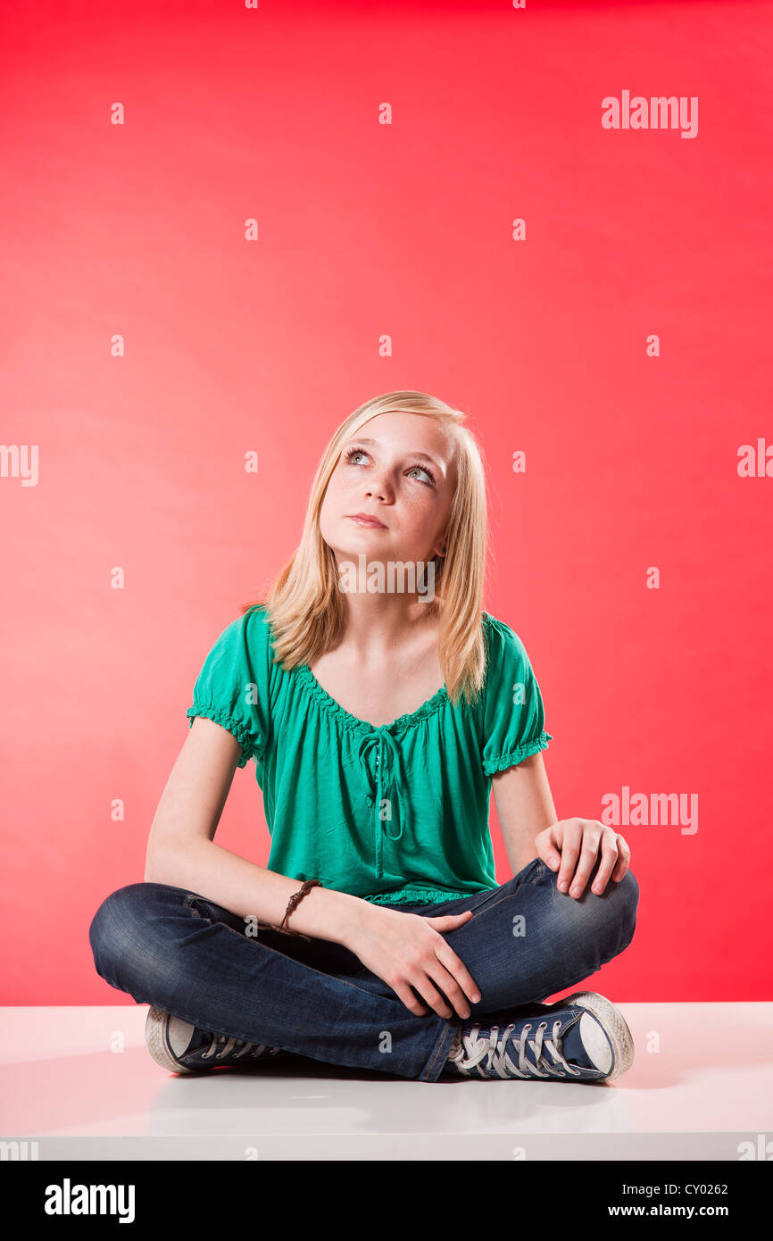 Girl sitting cross-legged Stock Photo - Alamy