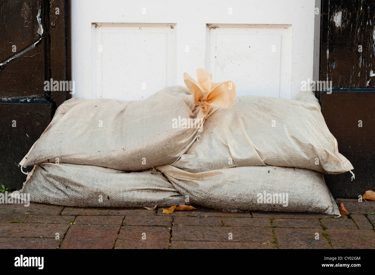 Sand bags used as flood defence on a home front door Stock Photo - Alamy