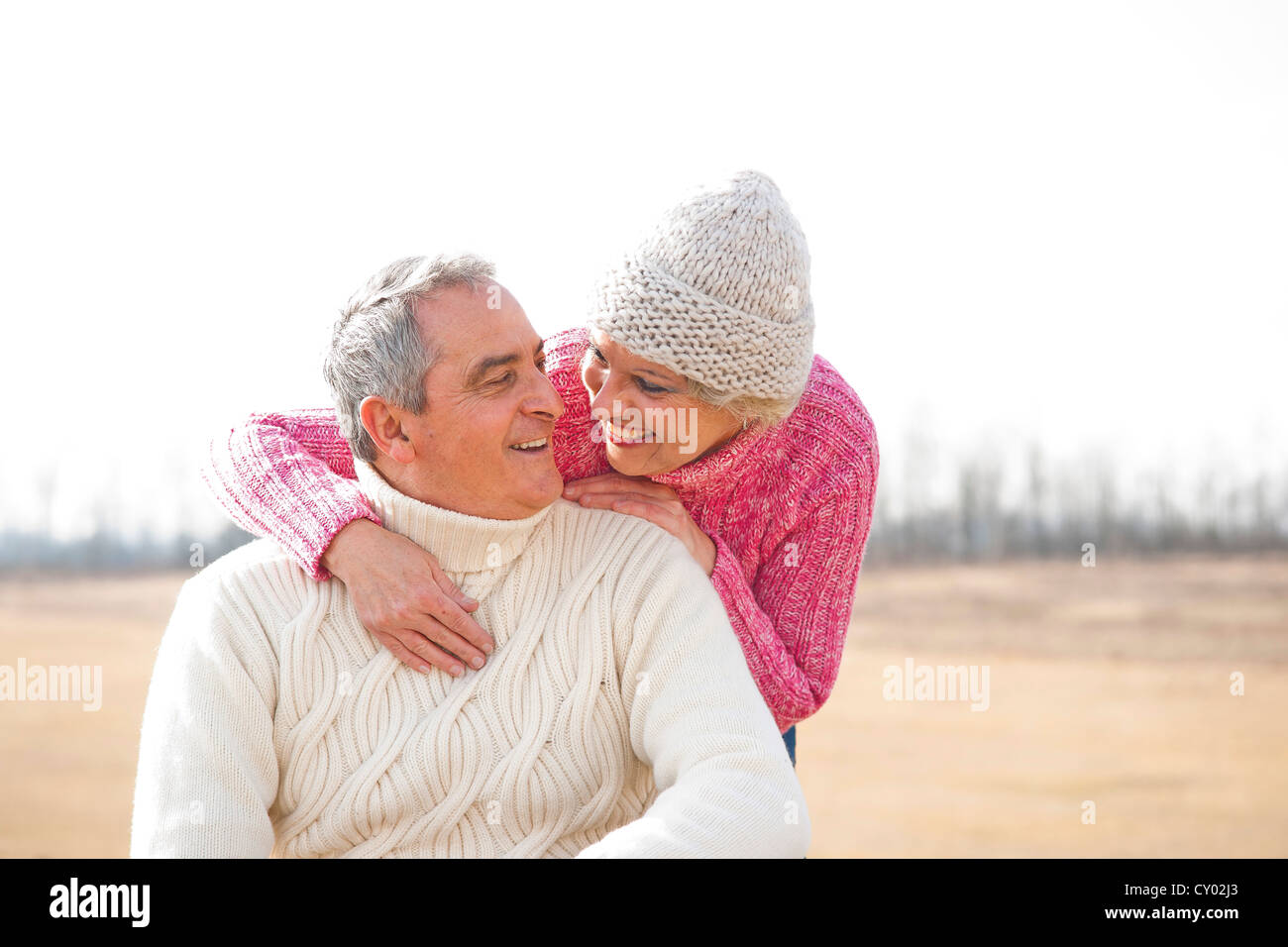 Elderly woman hugging her partner Stock Photo - Alamy