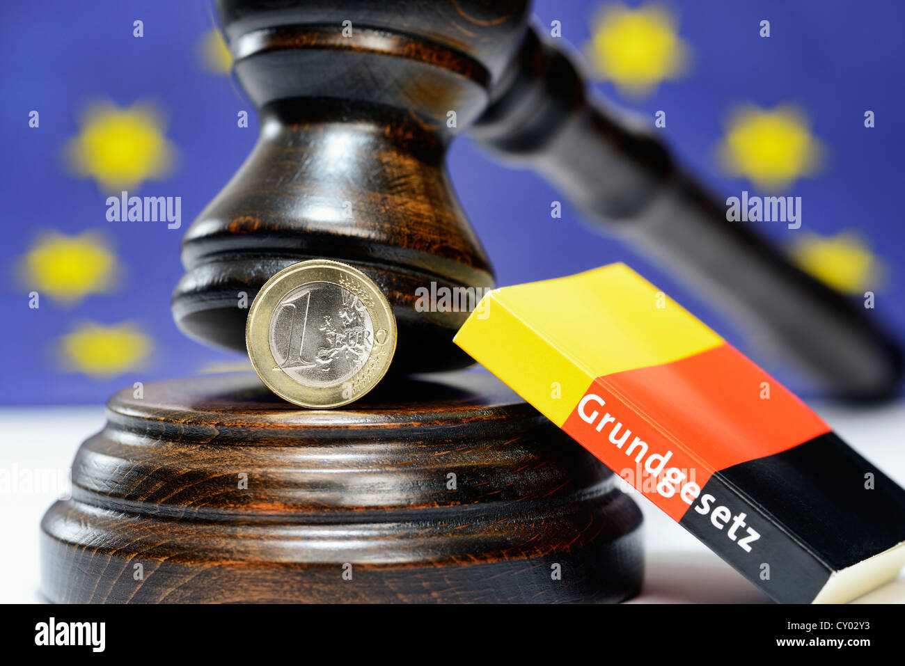An one-euro coin, a judge's gavel and a German constitution, symbolic ...