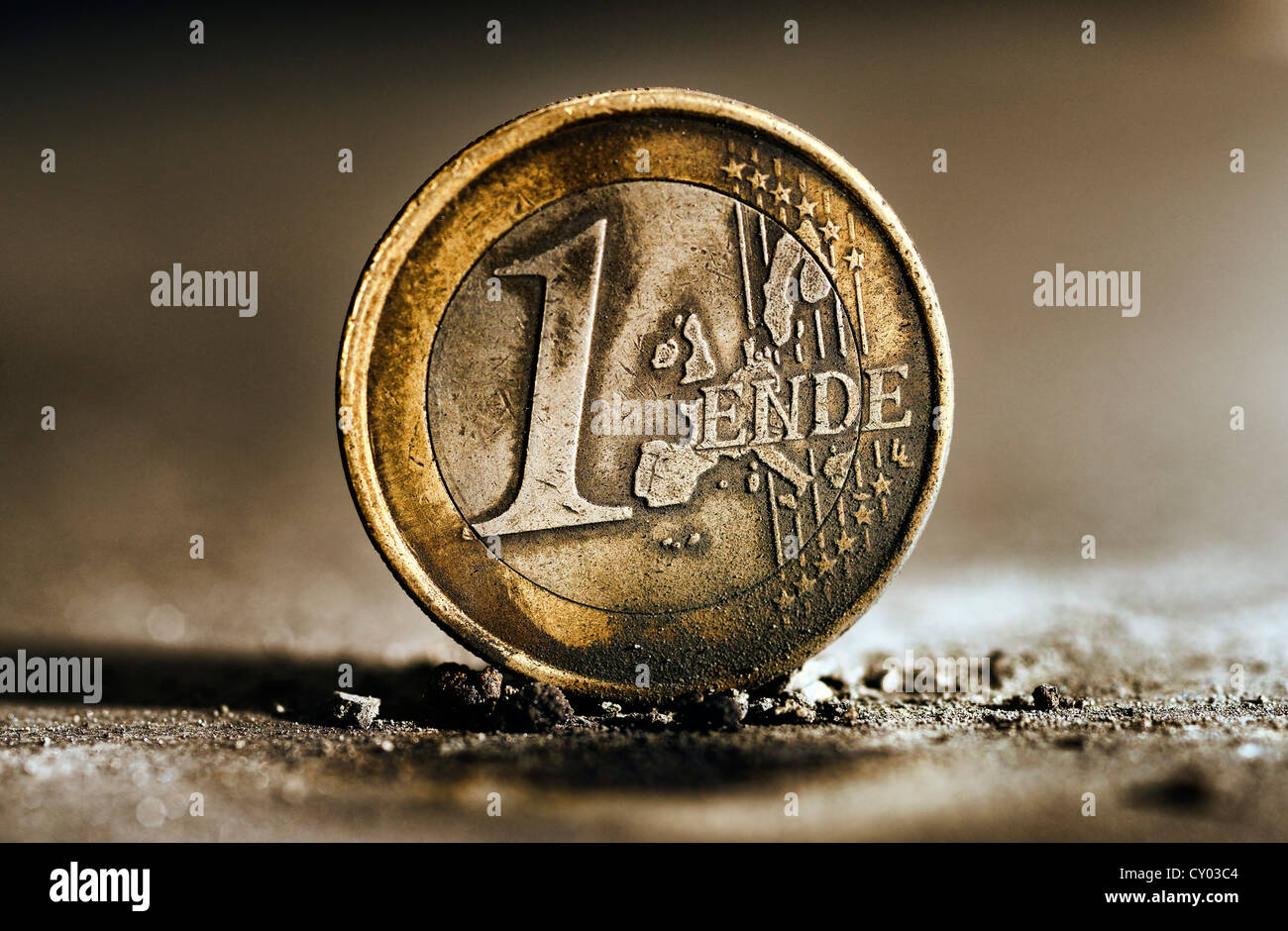 Burnt 1 euro coin, euro lettering altered to ende, German for end ...