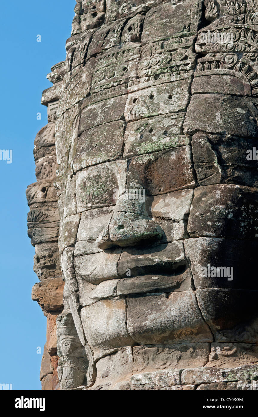 The smile of Angkor, huge face carved in stone on a tower, Bayon Temple ...