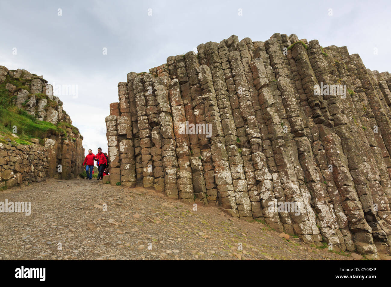 People walking through Giant's Gate between vertical columns of basalt ...