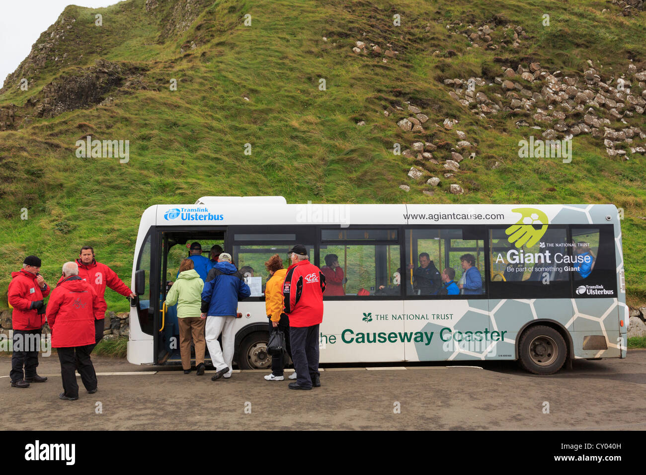 Tourists getting on a Causeway Coaster shuttle bus from Giant's ...