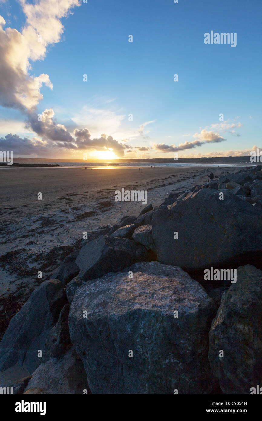 Cornwall, Mounts Bay beach and sea defenses rocks at dusk sunset ...