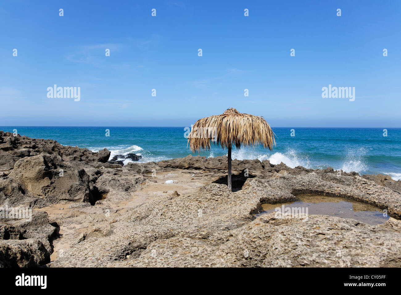 Parasol made of straw on the coast of the Atlantic Ocean, Tangier ...